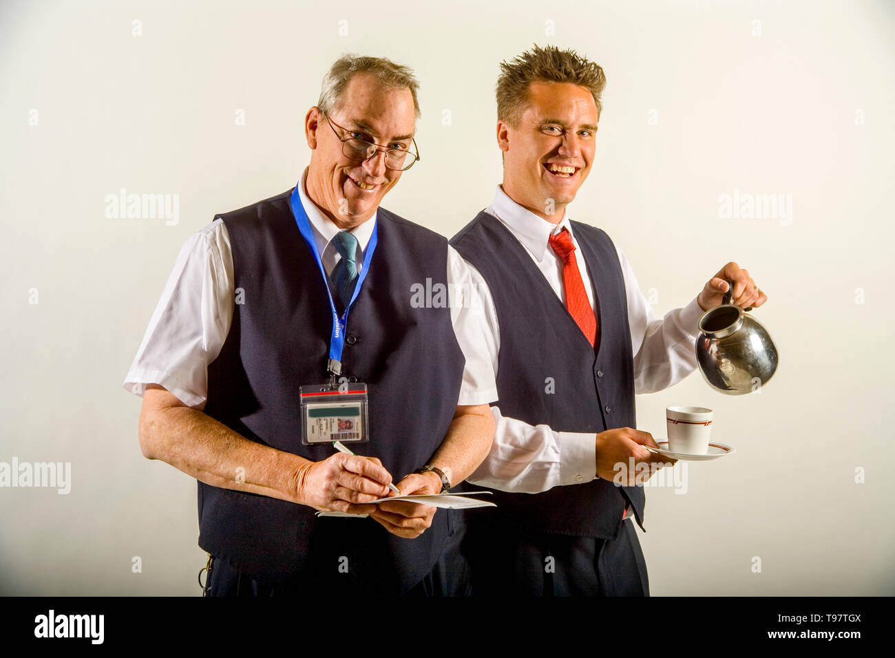 Two passenger train waiters pose at the Los Angeles train yards. One is ...