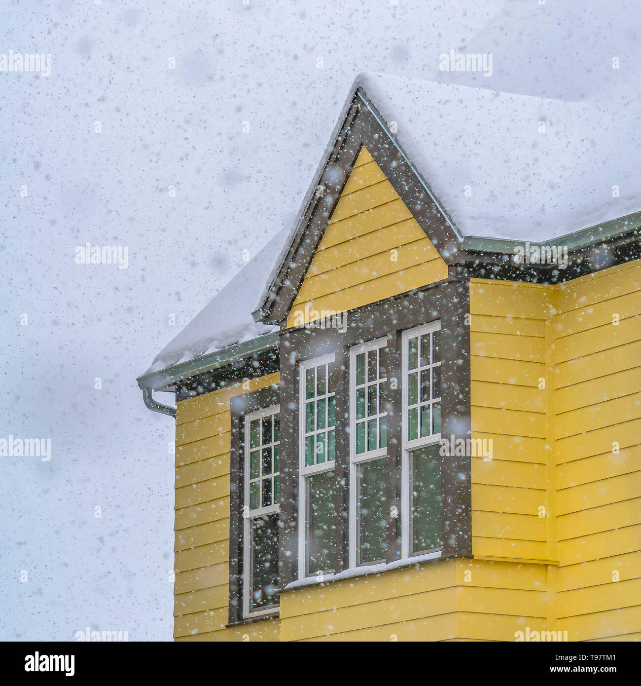 Clear Square Snow falling on a yellow home in Daybreak Utah Stock Photo ...