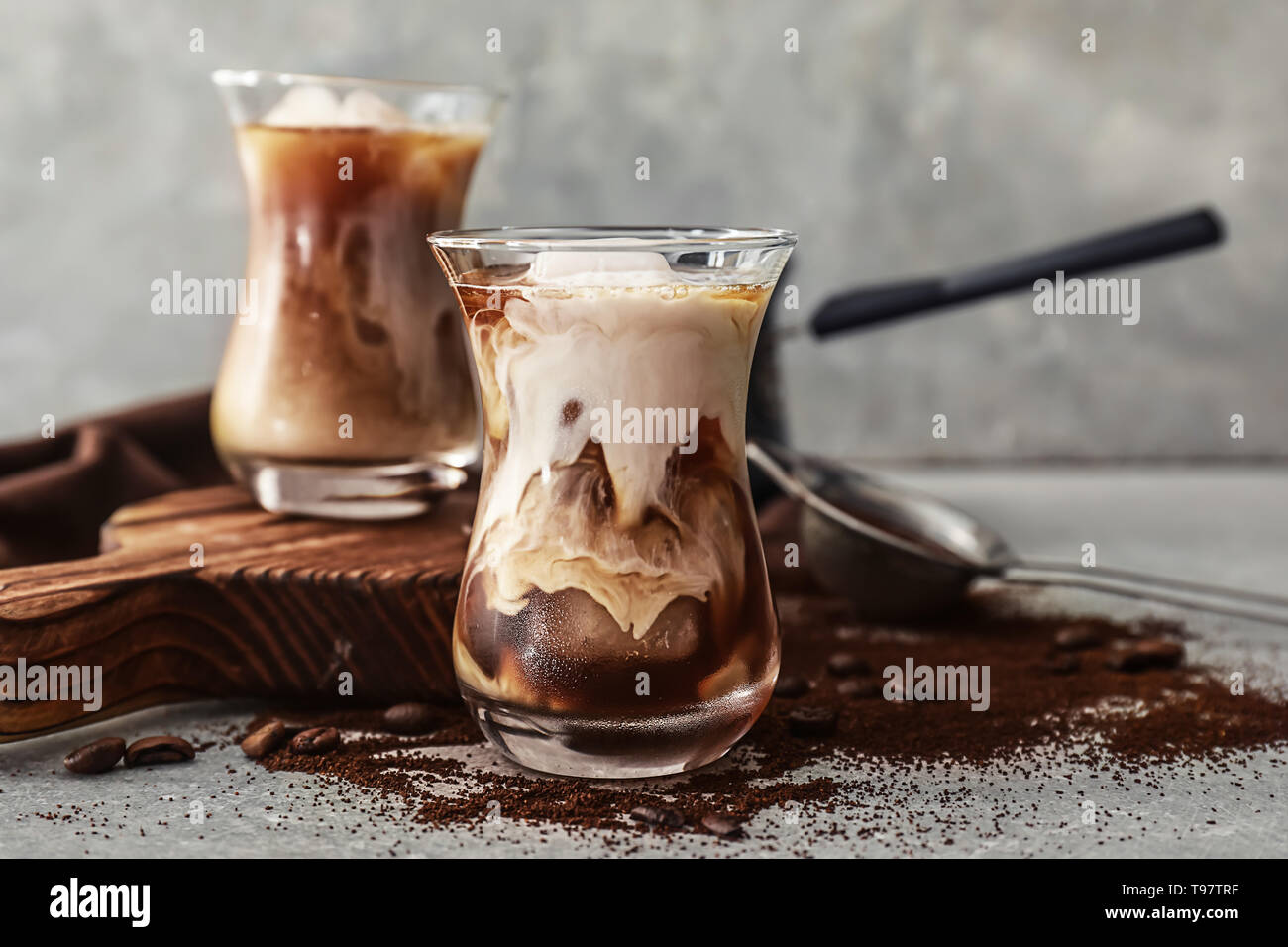 Glass with cold coffee on grey table Stock Photo - Alamy