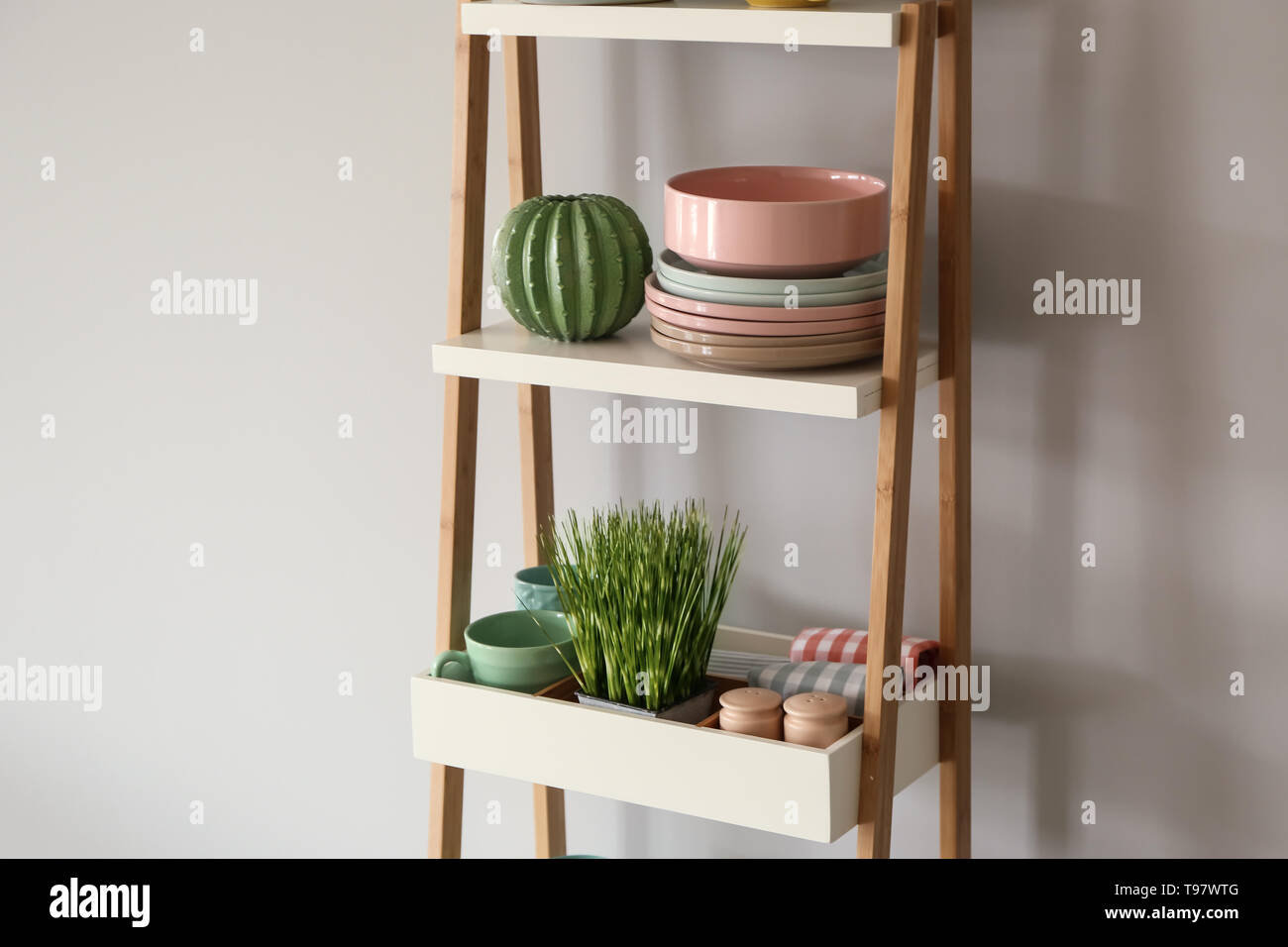 Set of clean tableware on shelving unit Stock Photo - Alamy