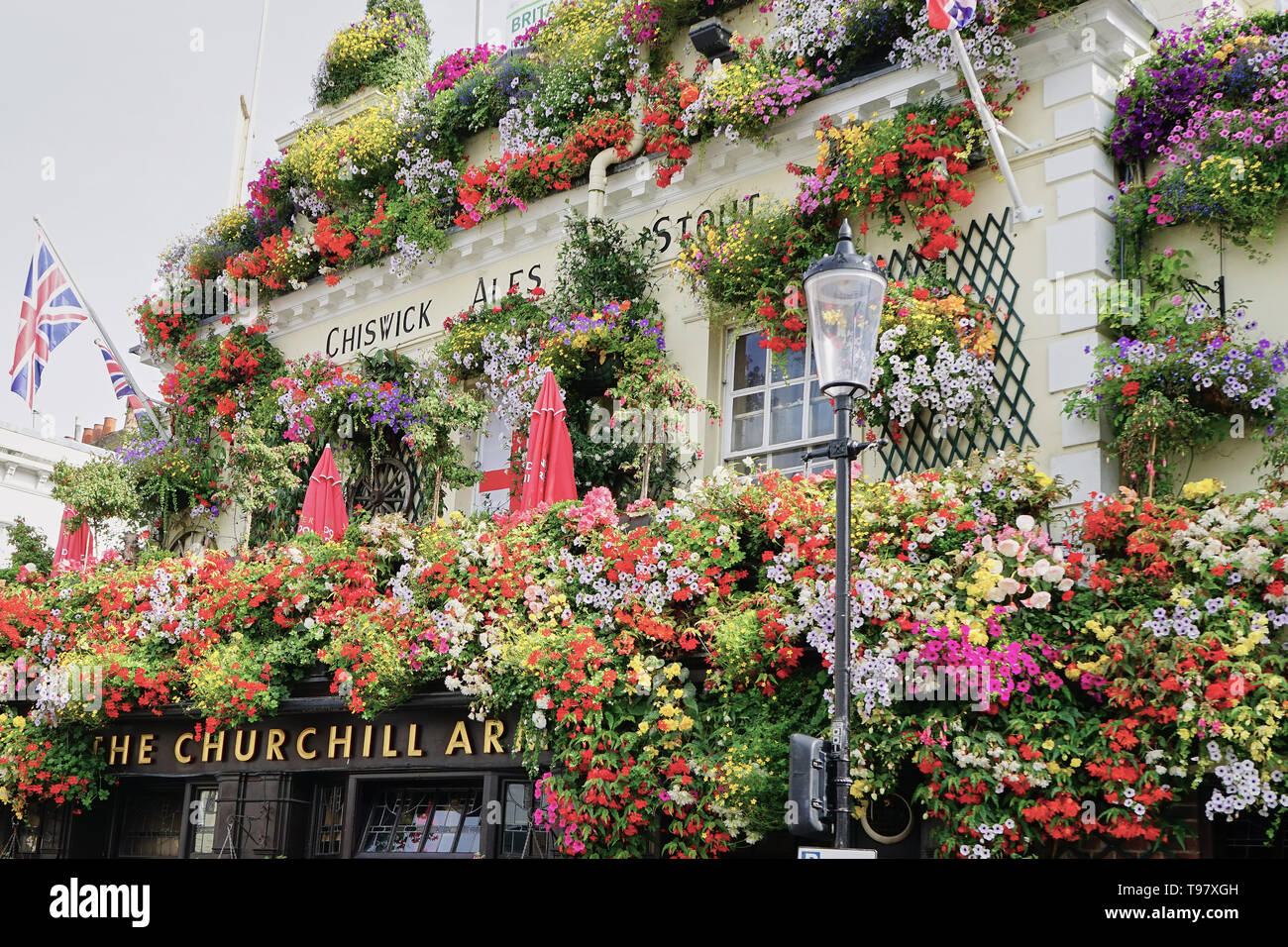 Churchill Arms Pub facade with cascading flower display Stock Photo - Alamy