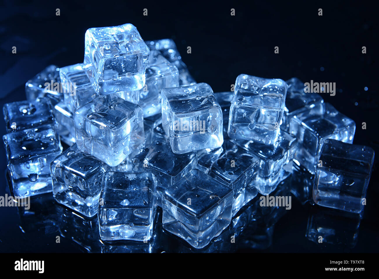 Ice cubes on dark background Stock Photo - Alamy