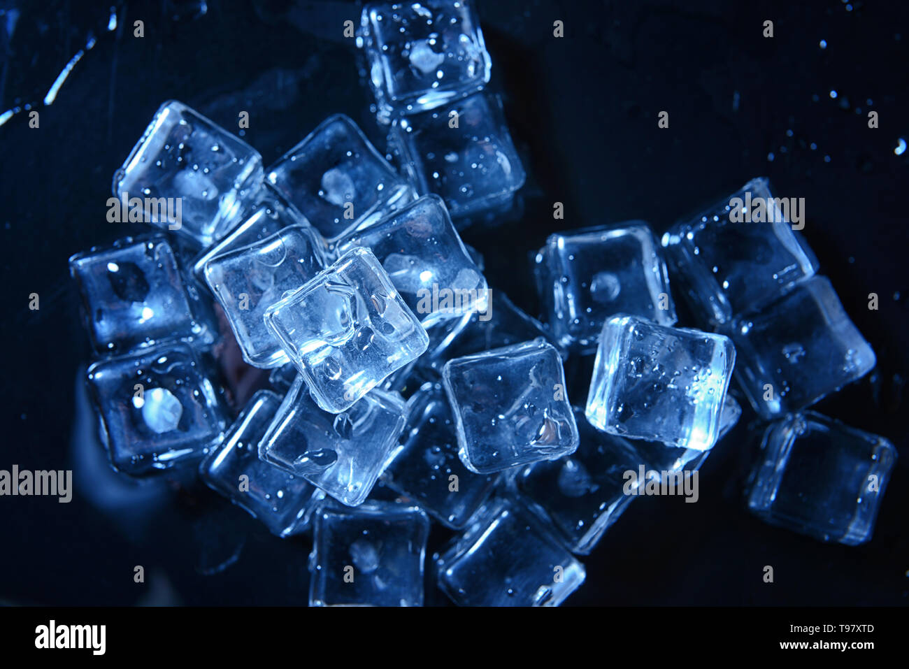 Ice cubes on dark background Stock Photo - Alamy