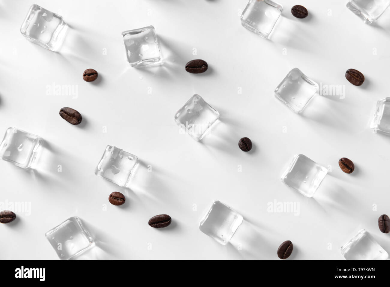 Ice cubes and coffee beans on white background Stock Photo - Alamy