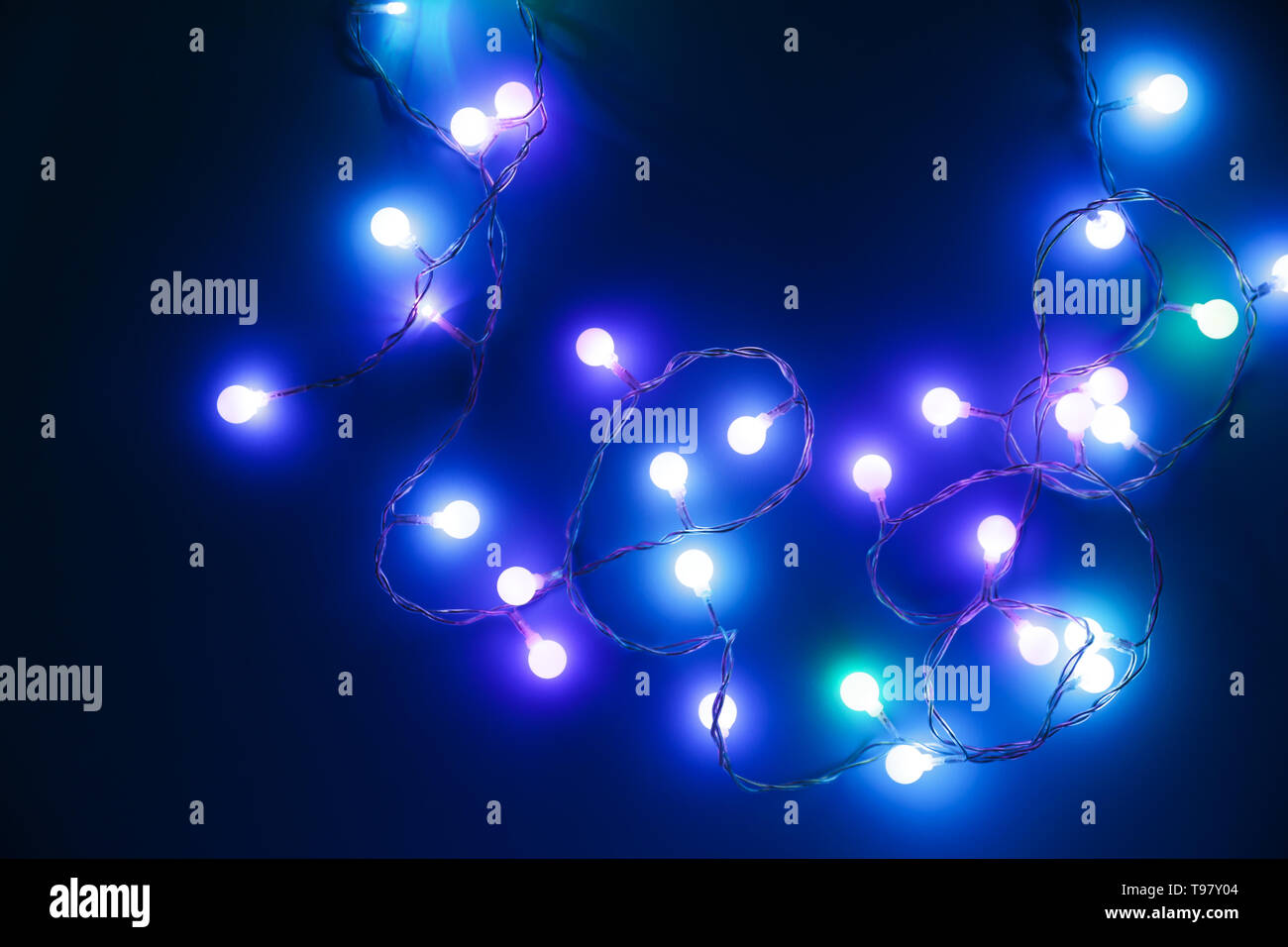Christmas lights on dark background, top view Stock Photo - Alamy