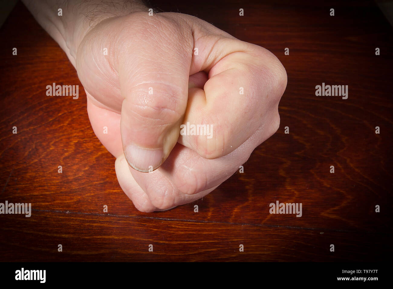 Clenched fist on table hi-res stock photography and images - Alamy