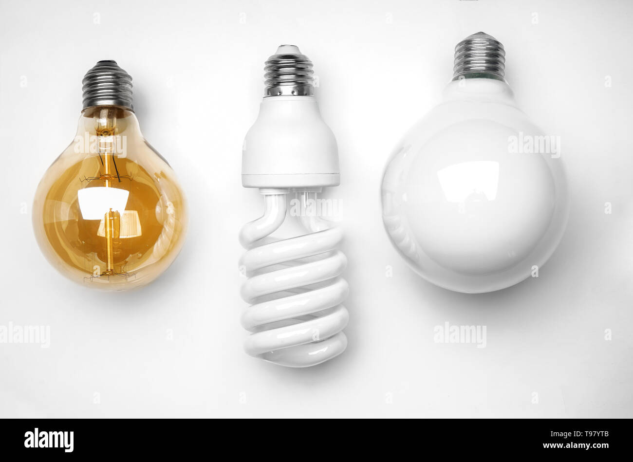 Different light bulbs on white background Stock Photo - Alamy