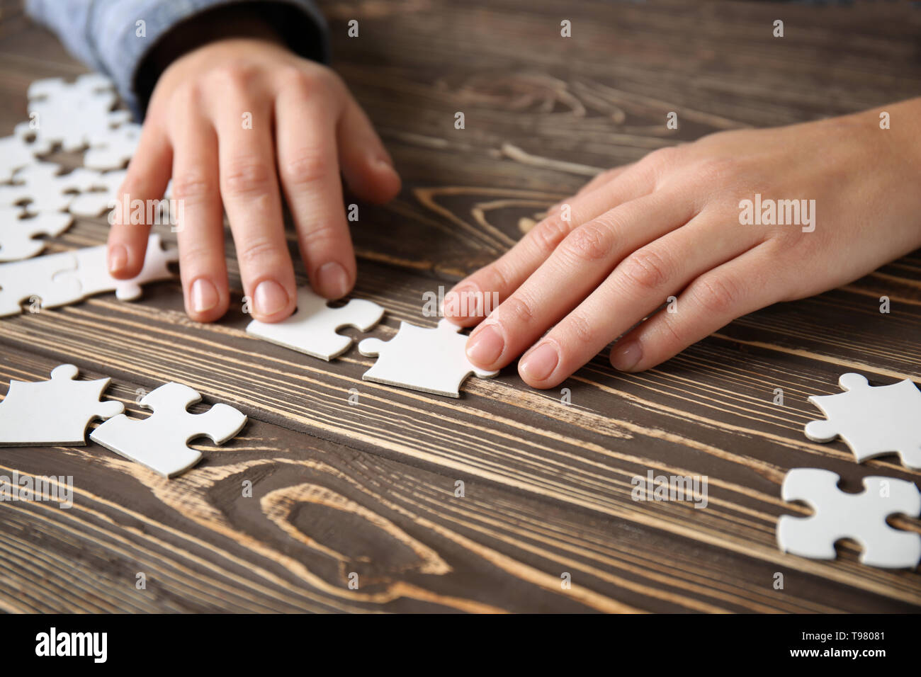 Young people doing jigsaw puzzle hi-res stock photography and images ...