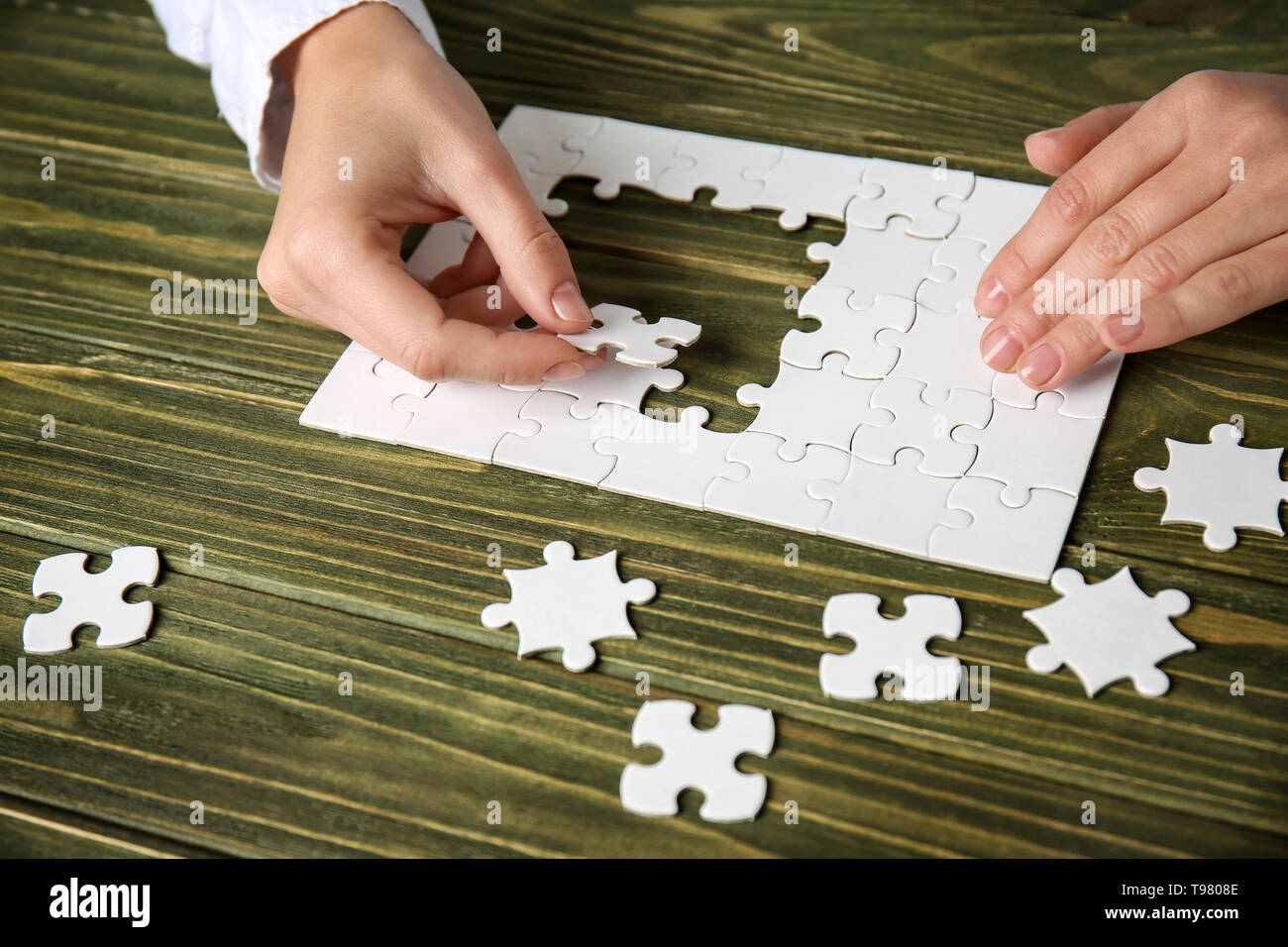 Woman doing puzzle hi-res stock photography and images - Alamy