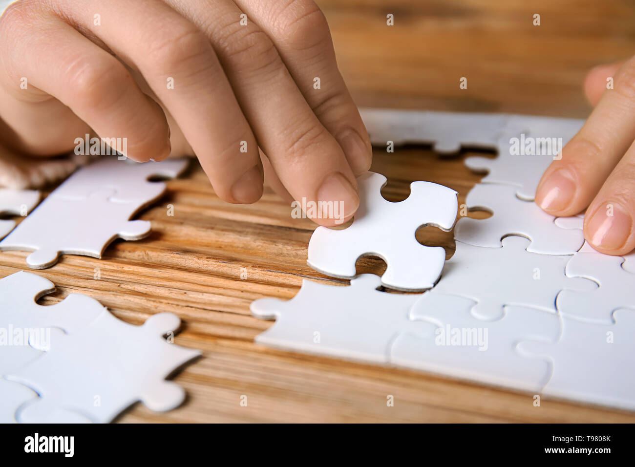 Young people doing jigsaw puzzle hi-res stock photography and images ...
