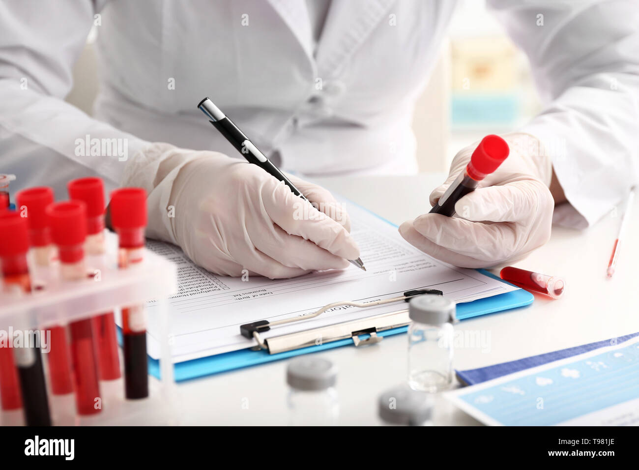 Woman working blood samples hi-res stock photography and images - Alamy