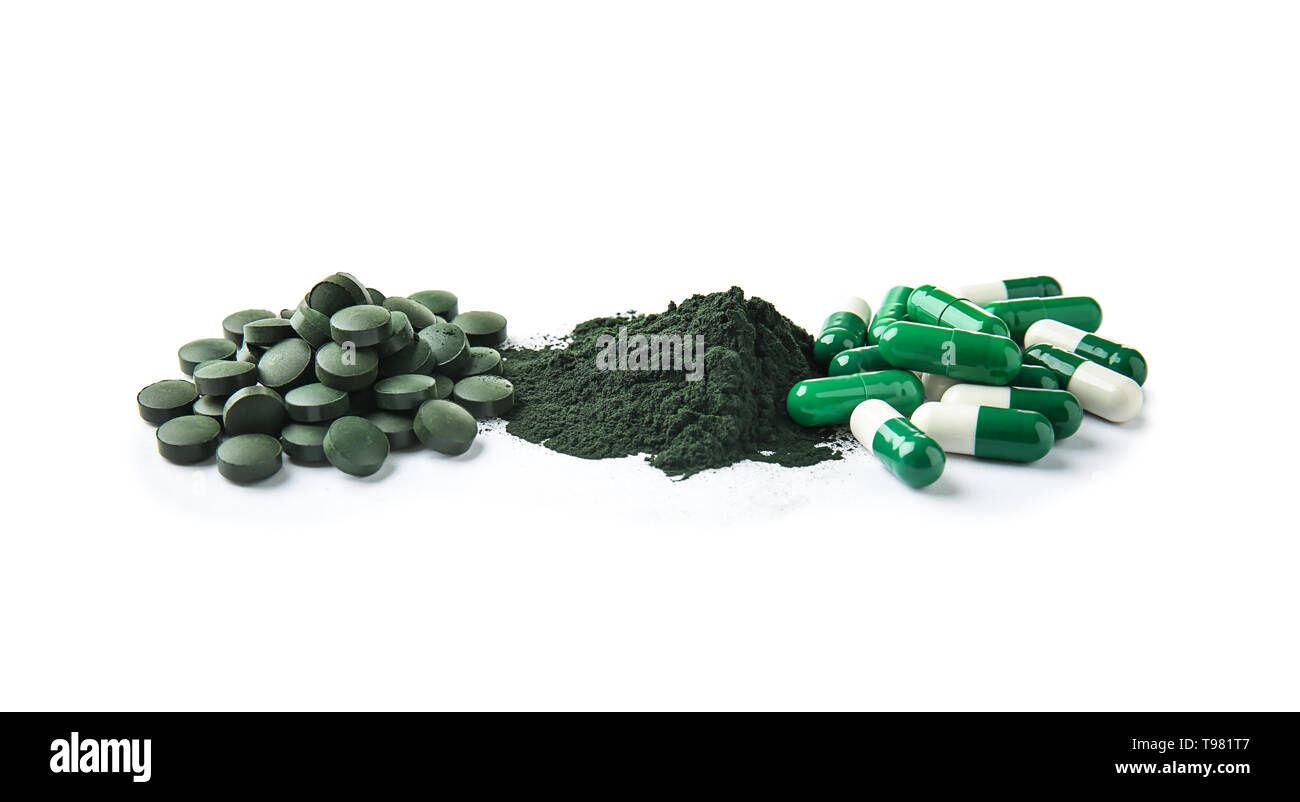Spirulina tablets with powder and capsules on white background Stock ...