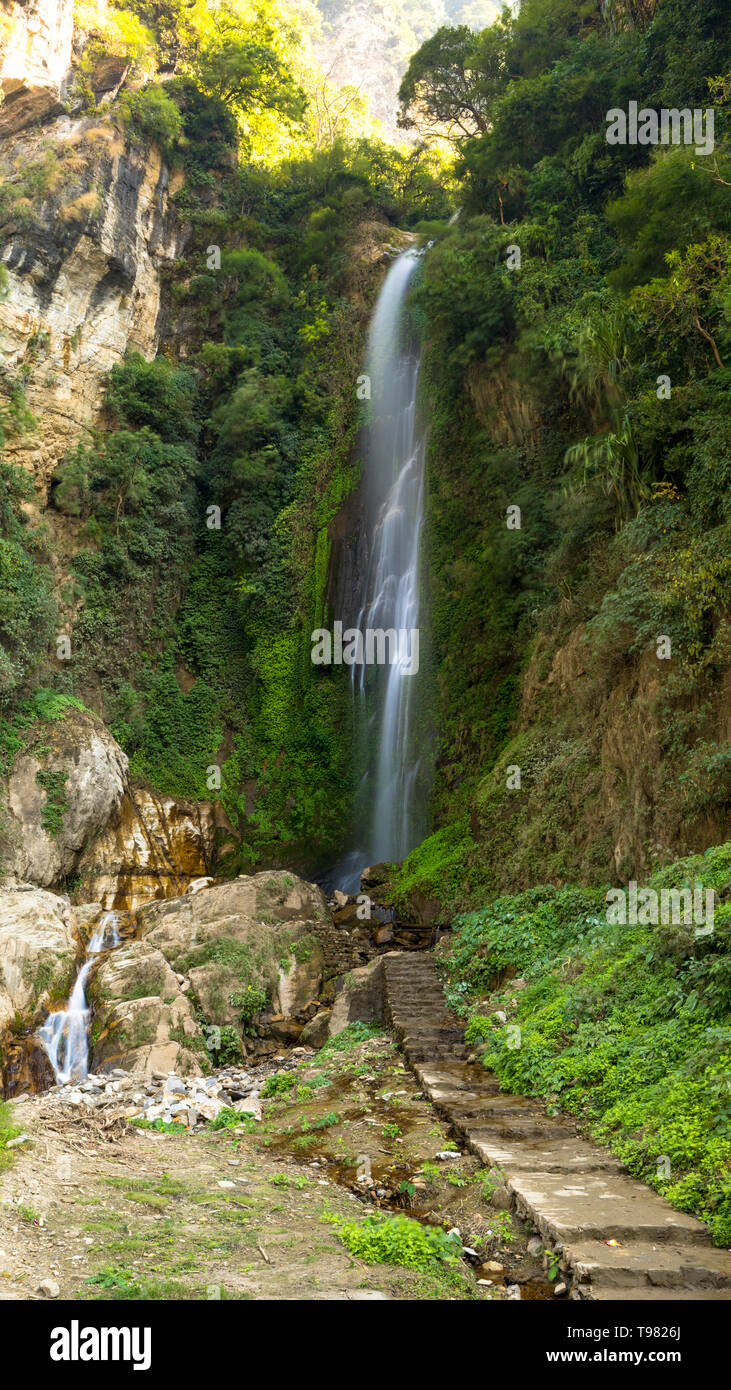 Waterfall on the way to Annapurna circuit, covered with green bushes ...