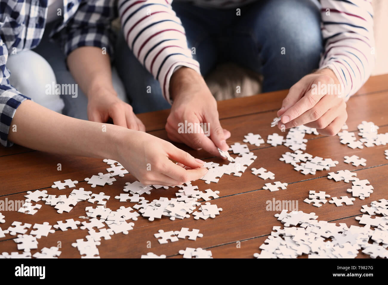 Young people doing jigsaw puzzle hi-res stock photography and images ...