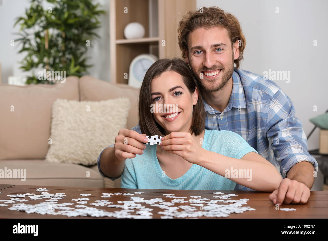 Young people doing jigsaw puzzle hi-res stock photography and images ...
