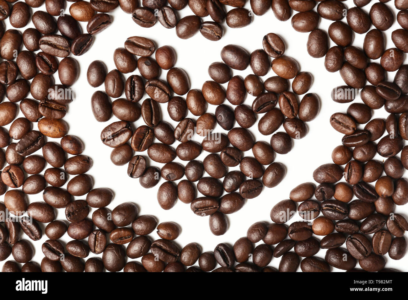 Heart made of roasted coffee beans on white background Stock Photo - Alamy