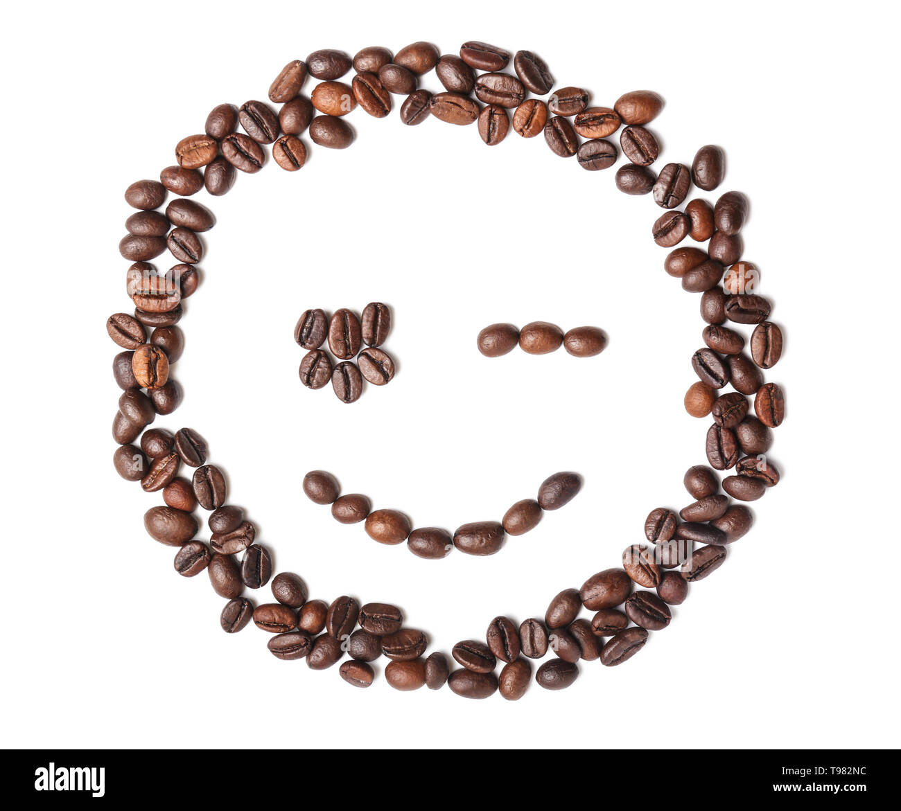 Funny smiling face made of roasted coffee beans on white background ...