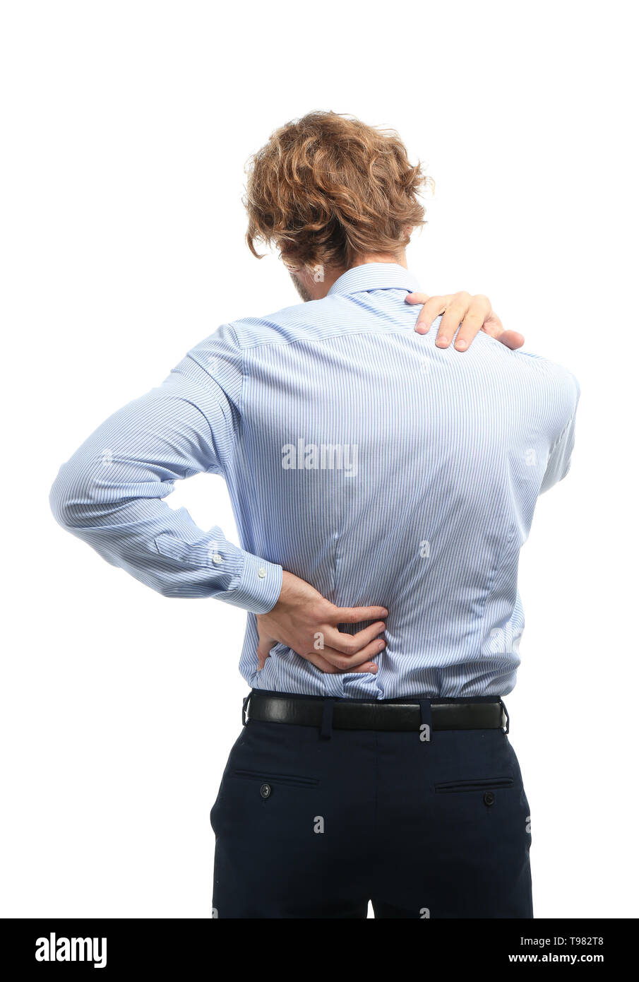 Young man suffering from back pain on white background Stock Photo - Alamy