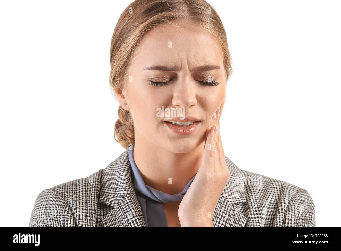 Young woman suffering from tooth ache on white background Stock Photo ...