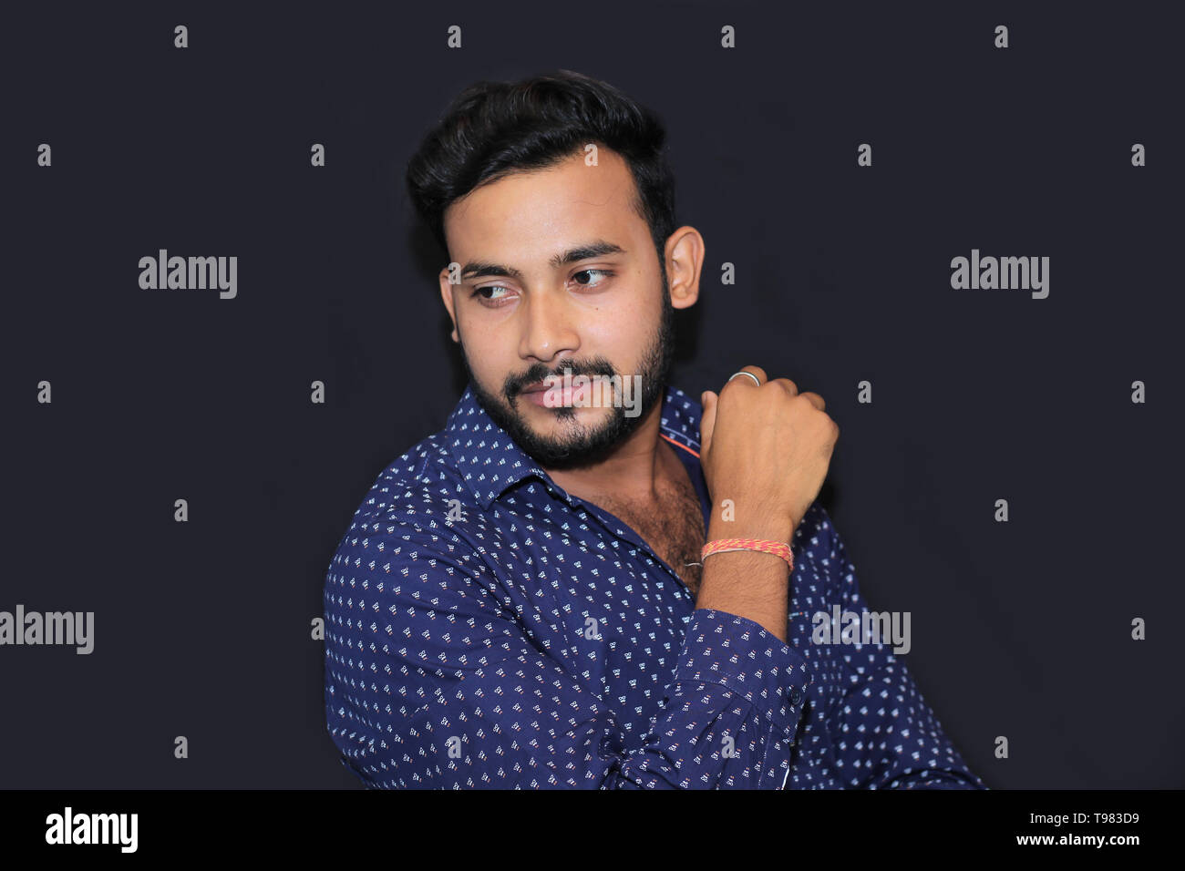 portrait of a handsome smart young man model with black background ...