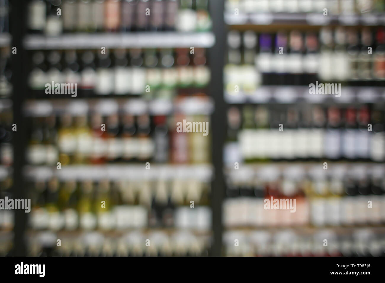 Blurred view of assorted alcohol drinks on shelves in store Stock Photo ...