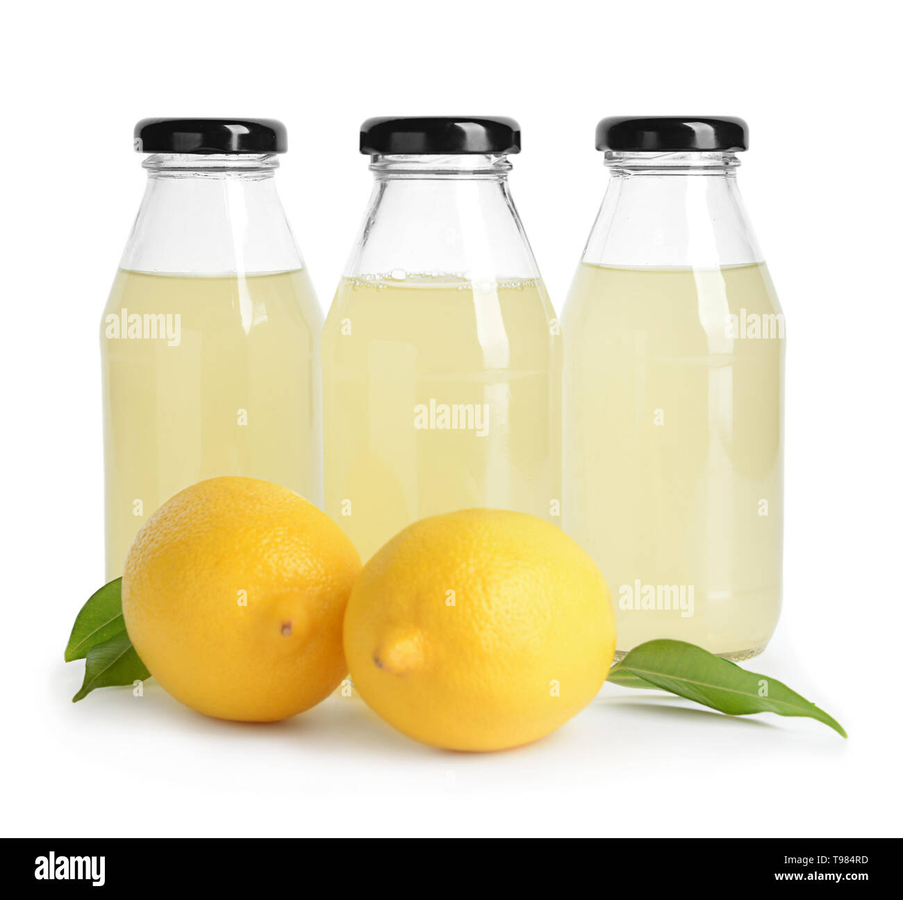 Bottles of fresh lemonade on white background Stock Photo - Alamy