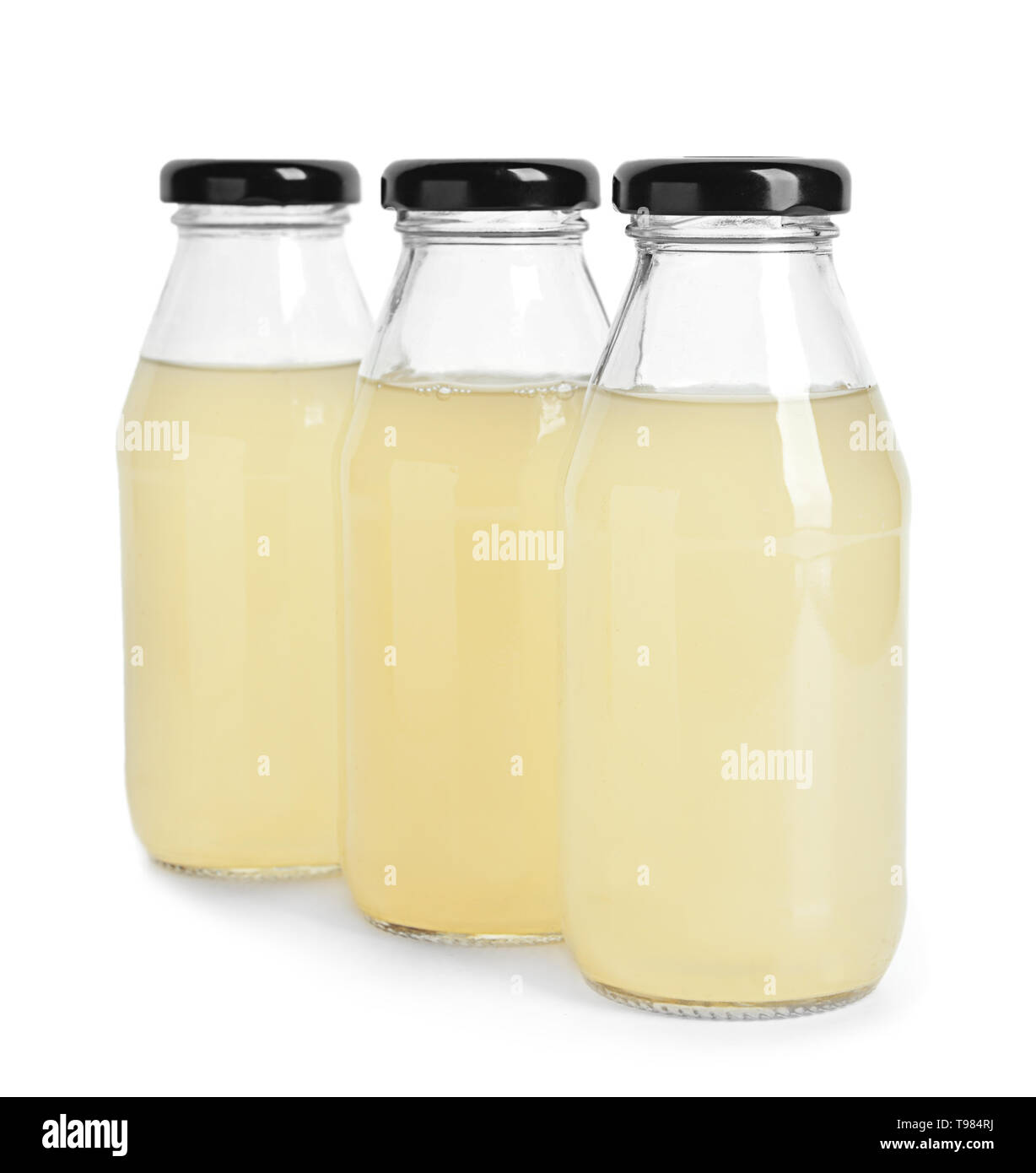 Bottles of fresh lemonade on white background Stock Photo - Alamy