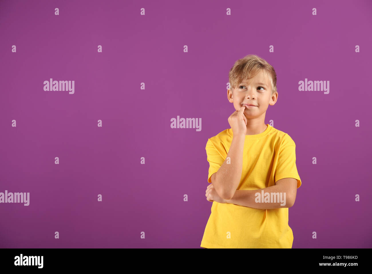Emotional boy after making mistake on color background Stock Photo - Alamy