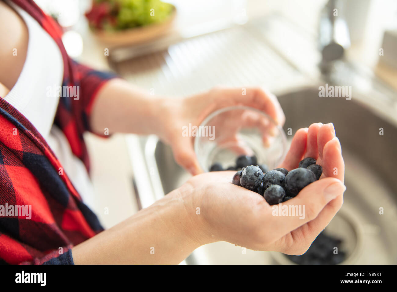Female eating blueberries hi-res stock photography and images - Alamy