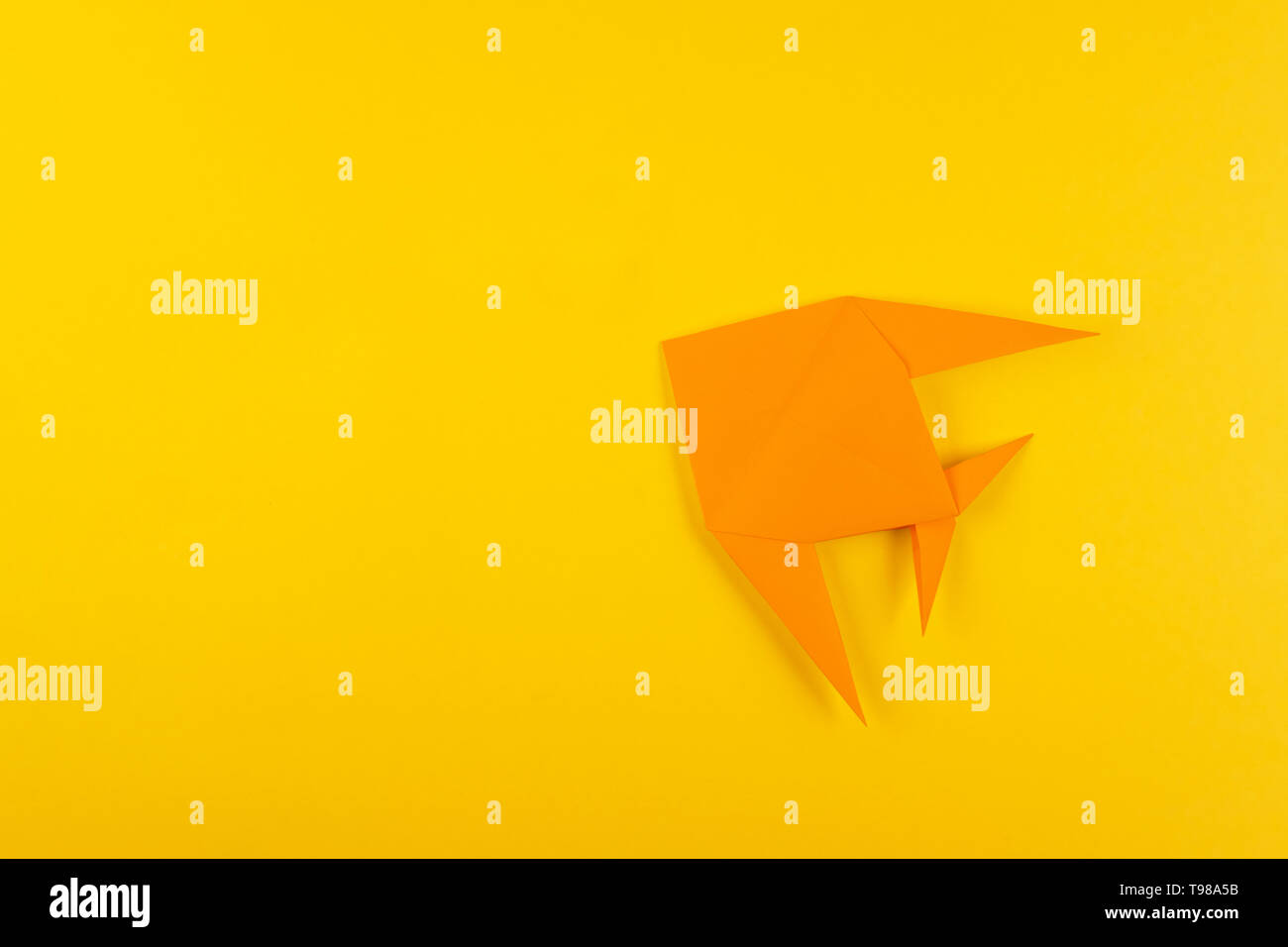 Origami tropical fish on yellow minimalistic background. Paper sea fish ...