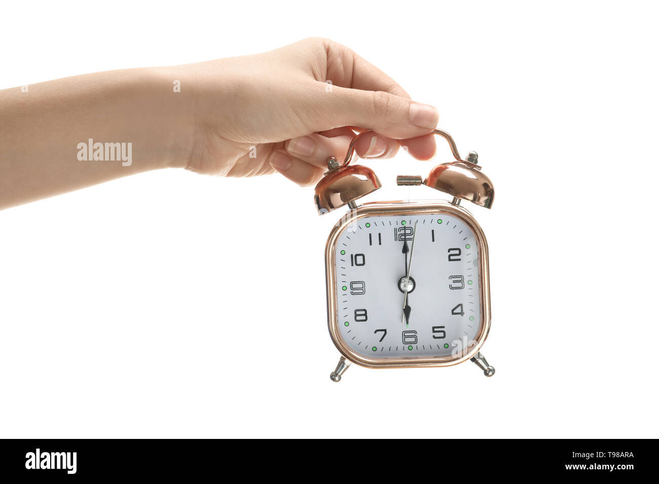 Female hand with alarm clock on white background Stock Photo - Alamy