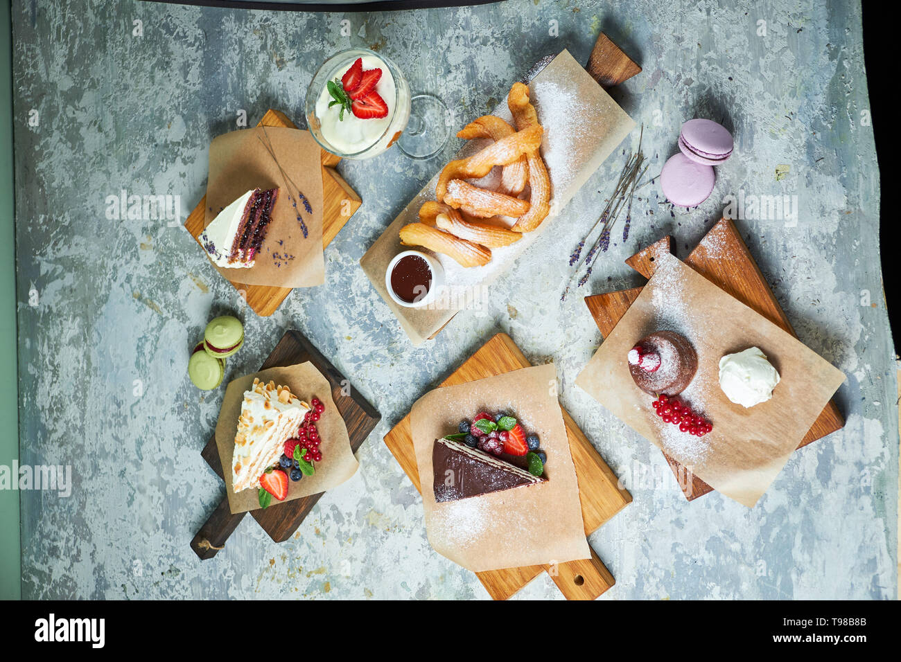 Assorted sweet desserts: cake, churos, meringue roll, ice cream ...