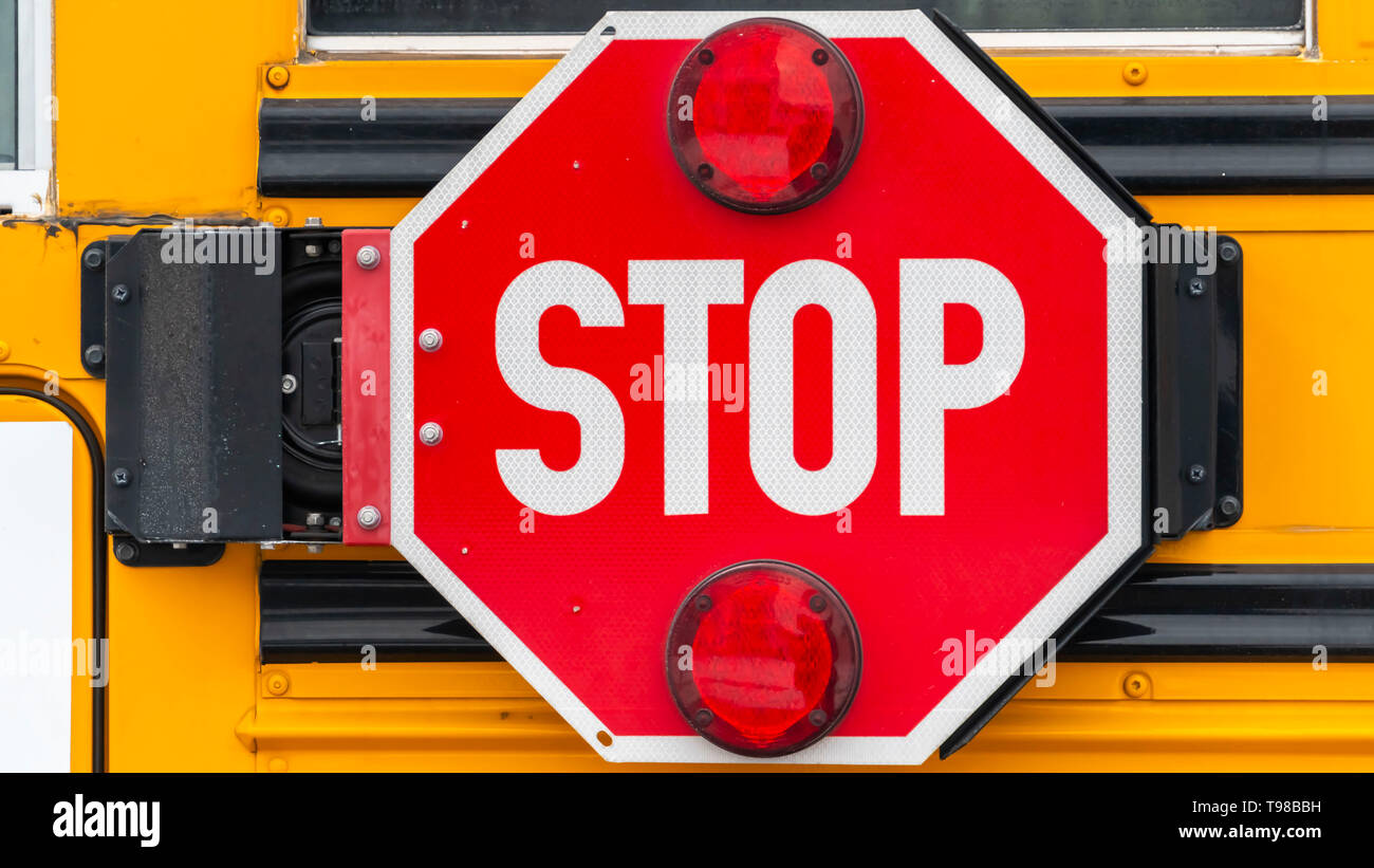 Panorama Close up of an octagon shaped red stop sign with signal lights ...