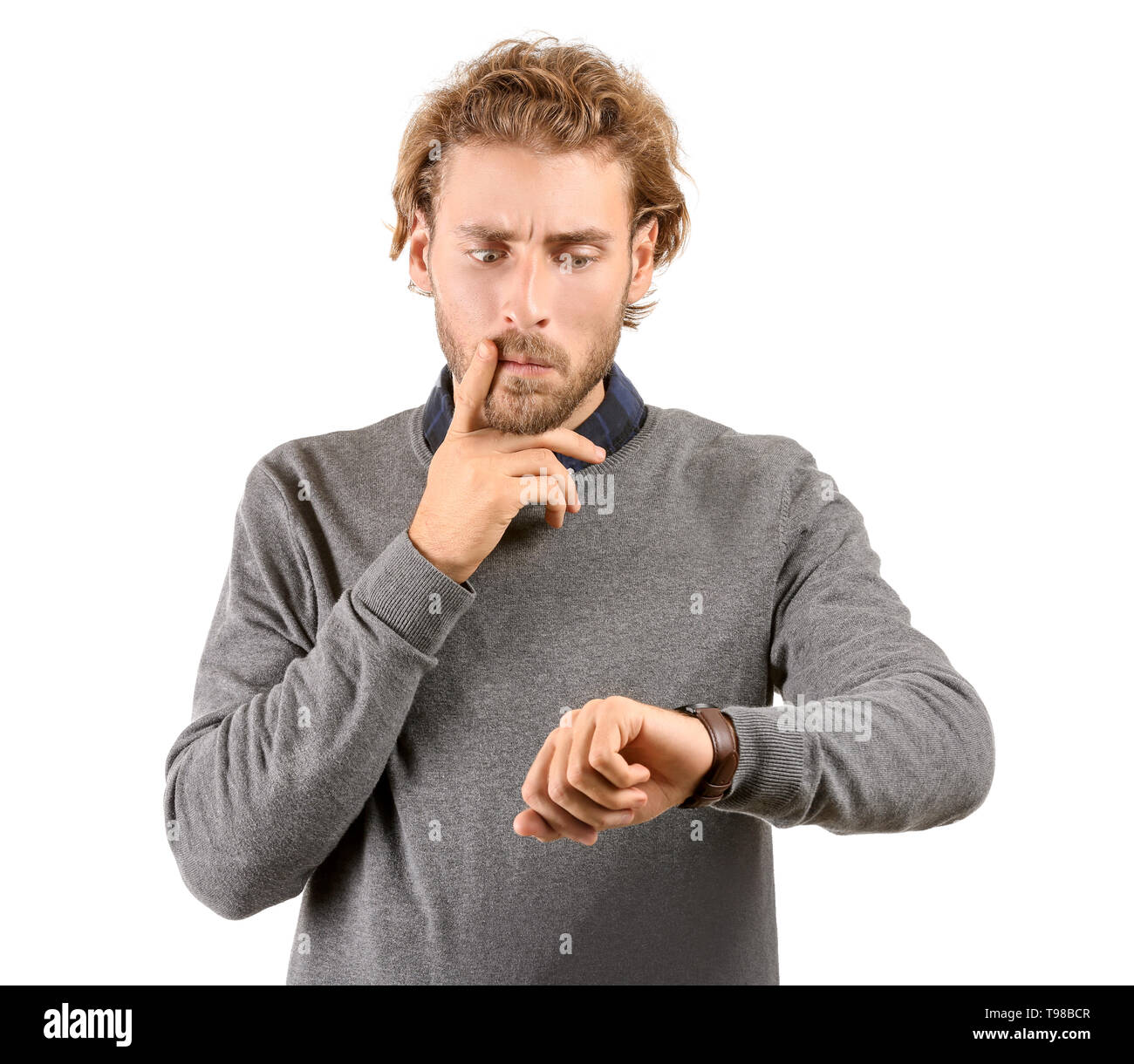 Stressed man looking at his watch on white background Stock Photo - Alamy