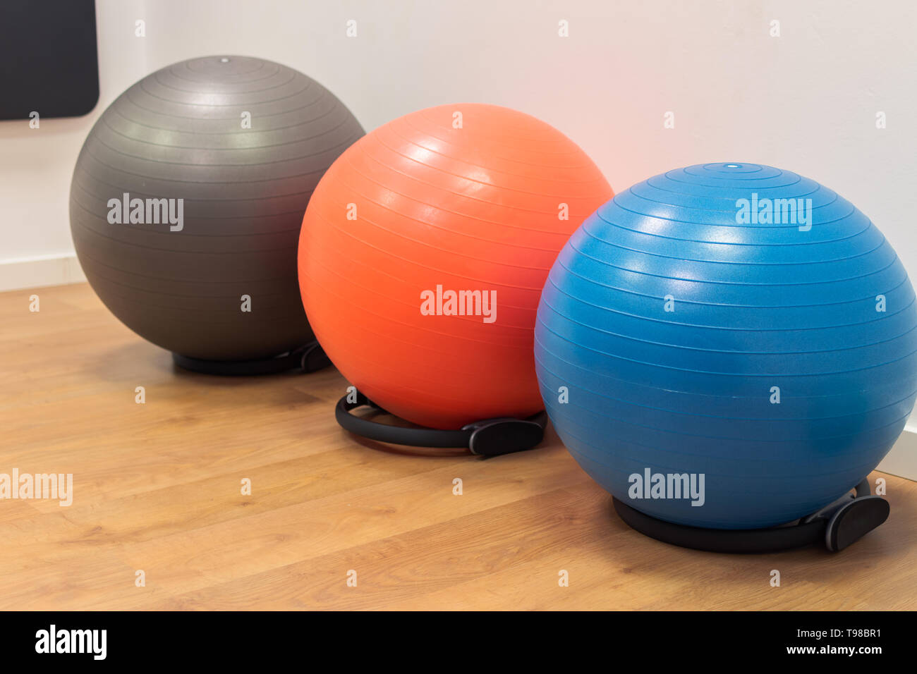 Fitness balls on wooden floor in the sport center. Exercise with gym ...