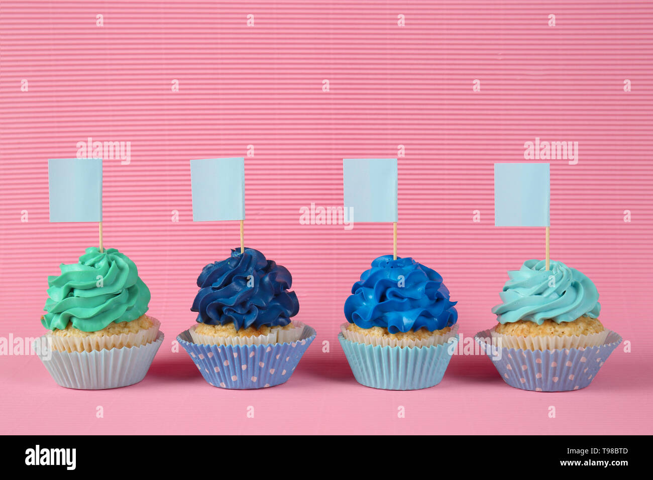 Different cupcakes on color background Stock Photo - Alamy
