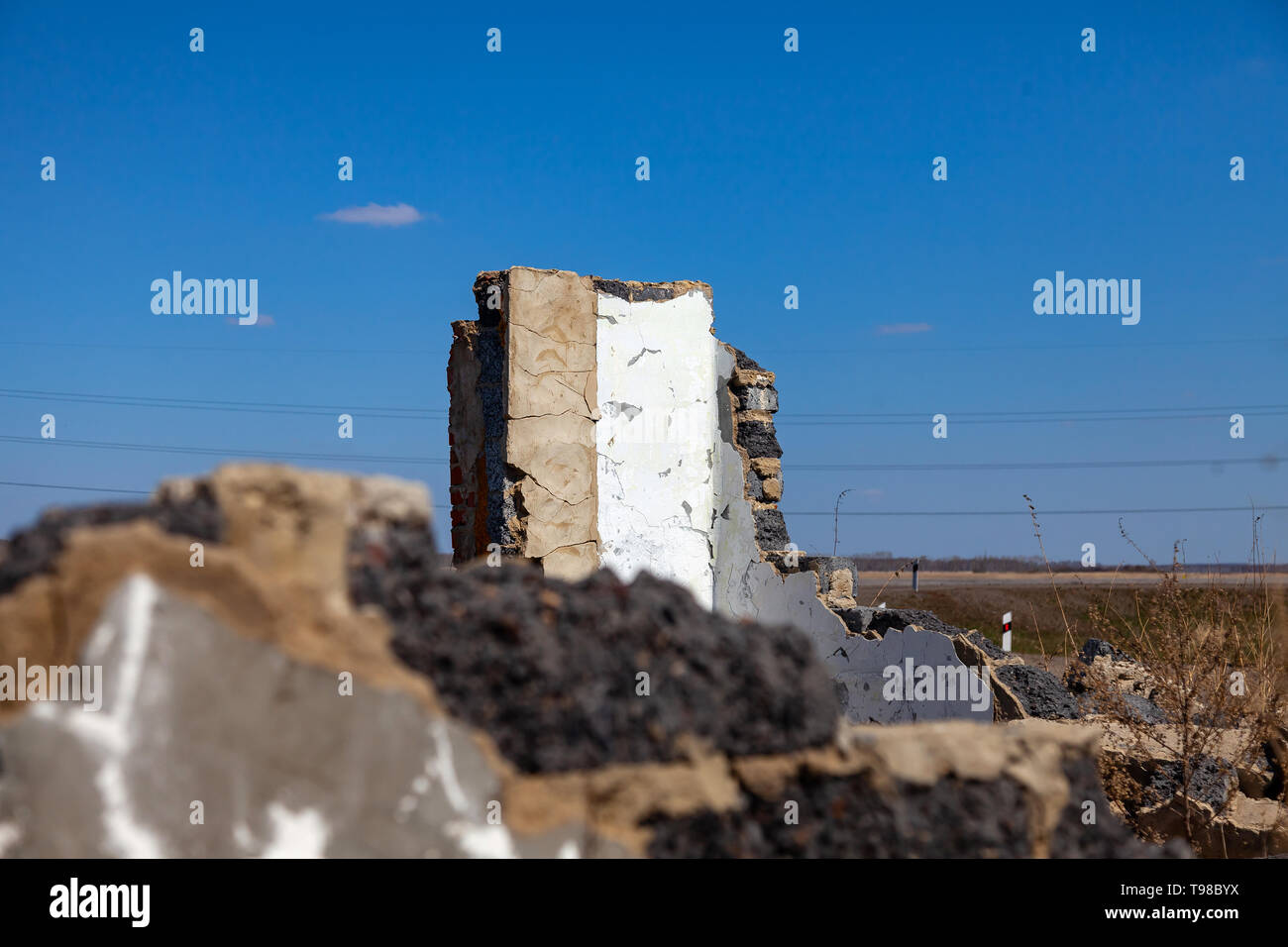 Abandoned and destroyed building from which only the wall remains and ...