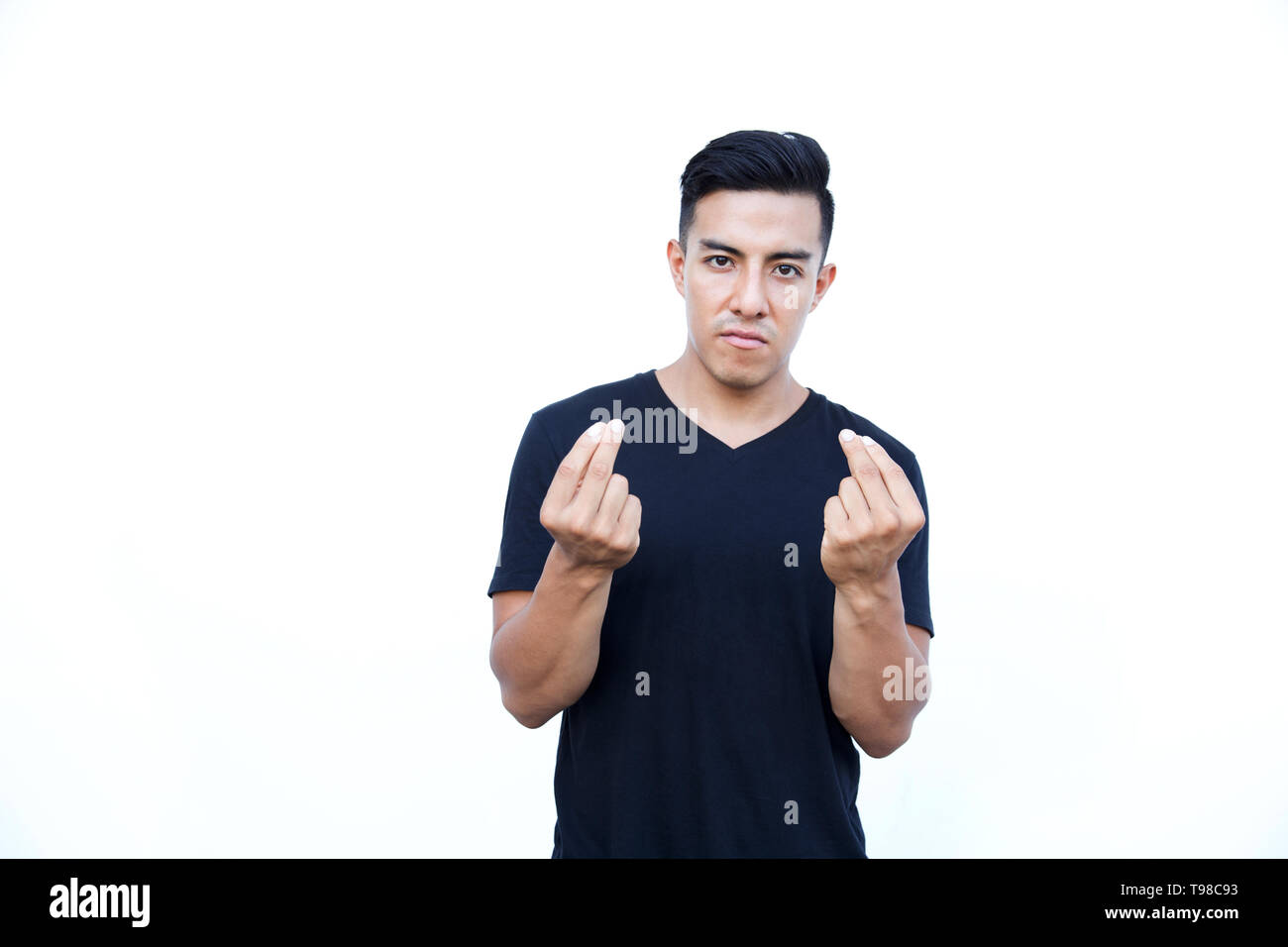 Handsome serious young man making money gesture isolated on white ...