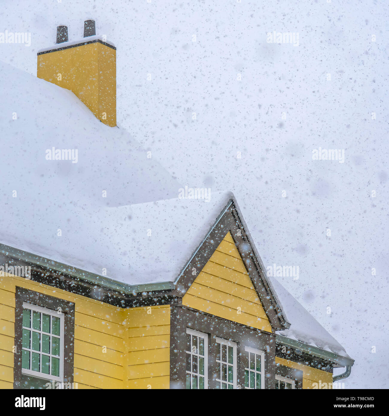 Square Snow falling on a yellow home in Daybreak Utah Stock Photo - Alamy