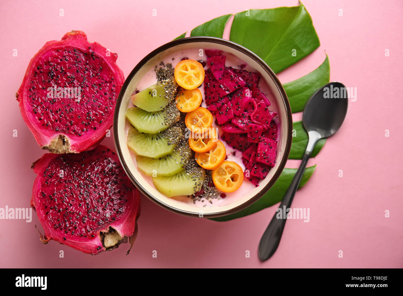 Yogurt with different fruits in bowl on color background Stock Photo ...