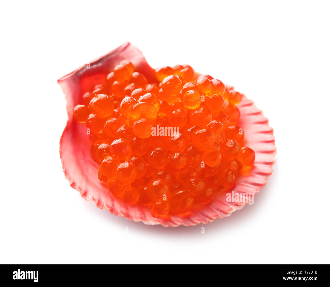 Sea shell with delicious red caviar on white background Stock Photo - Alamy
