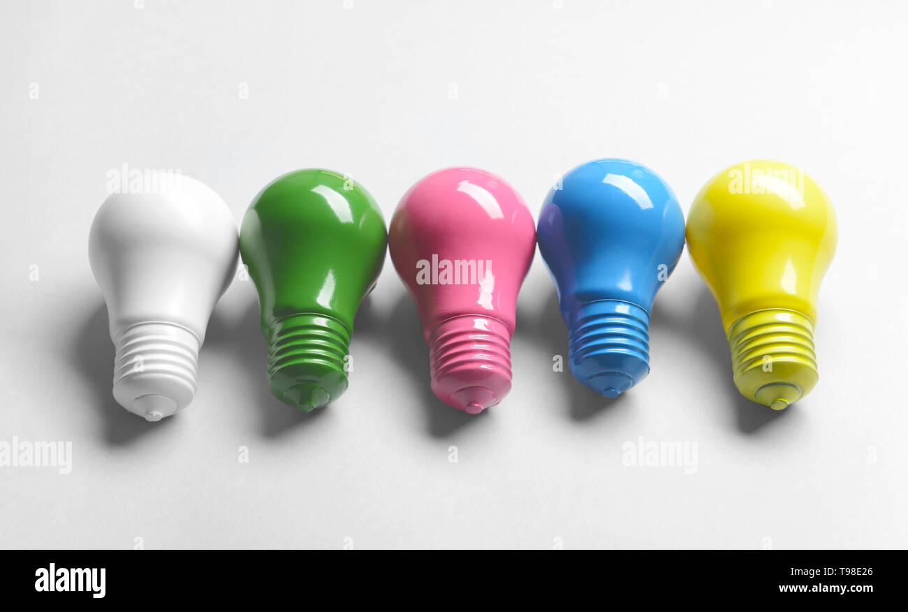 Painted light bulbs on white background Stock Photo - Alamy