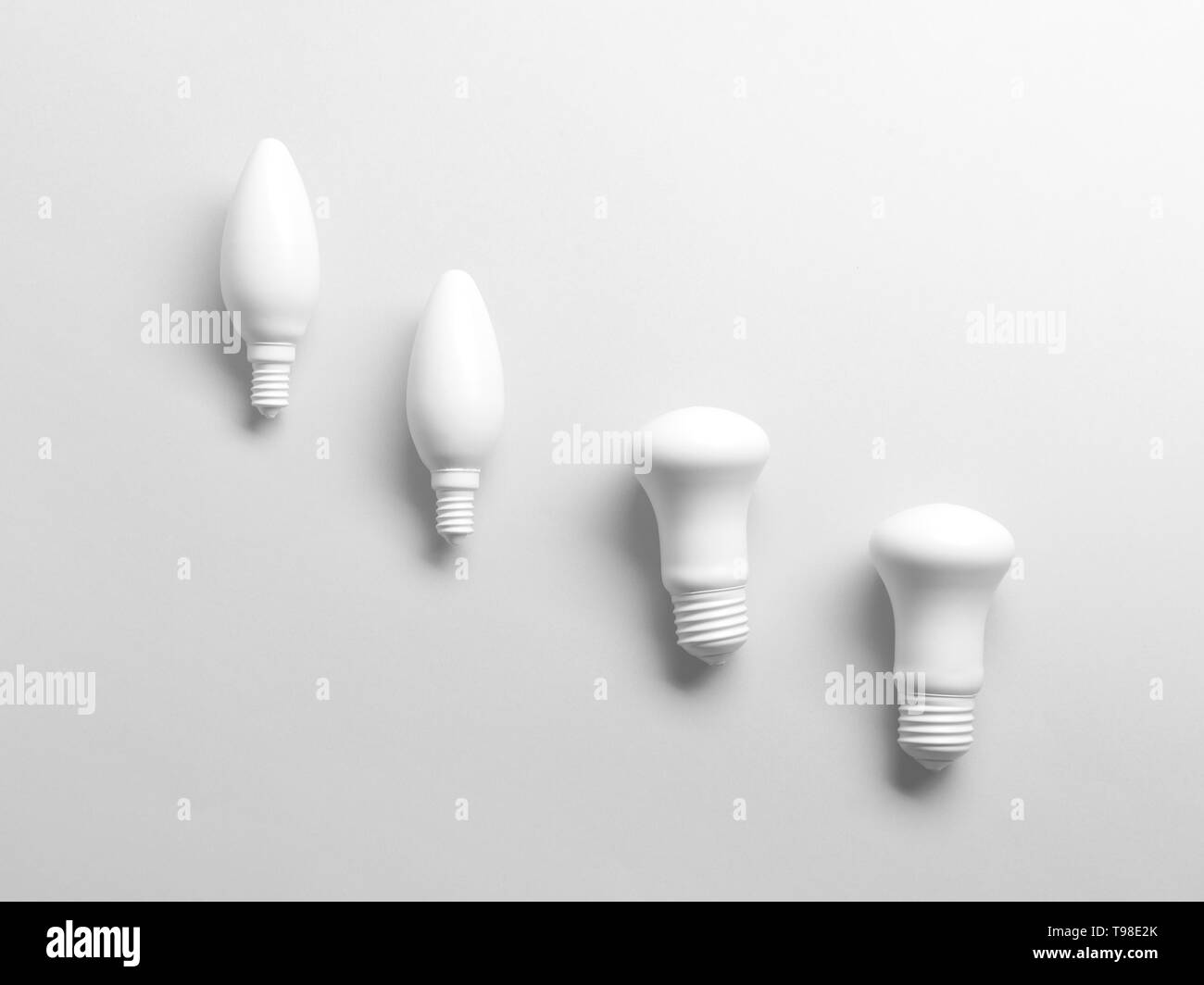Different light bulbs on white background Stock Photo - Alamy