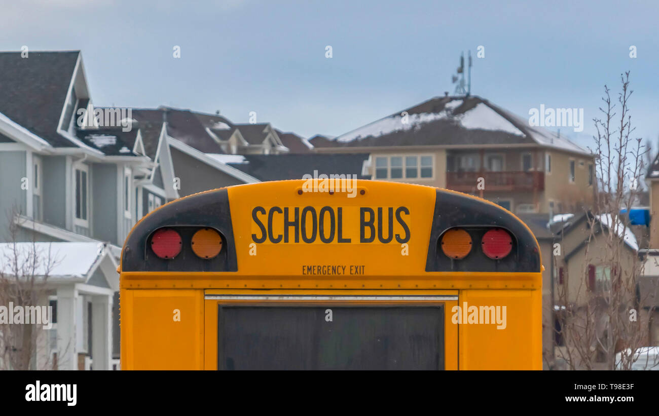 Clear Panorama Rear view of a yellow school bus with a window and ...
