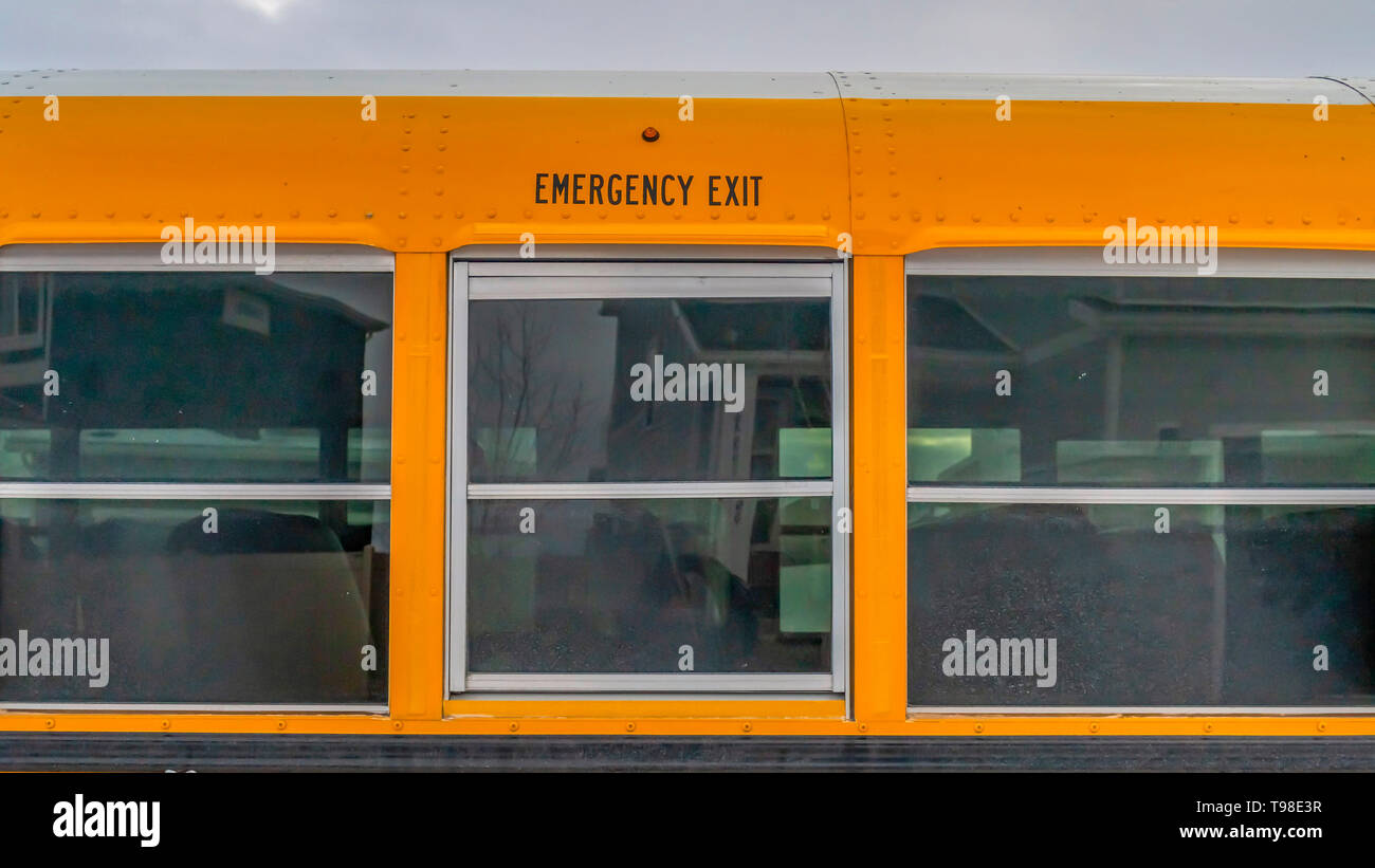 Clear Panorama CLose up of the exterior of a yellow school bus against ...