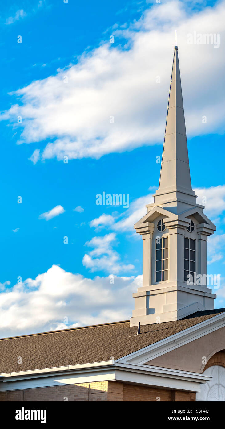 Clear Vertical Exterior of a beautiful church with a white steeple ...