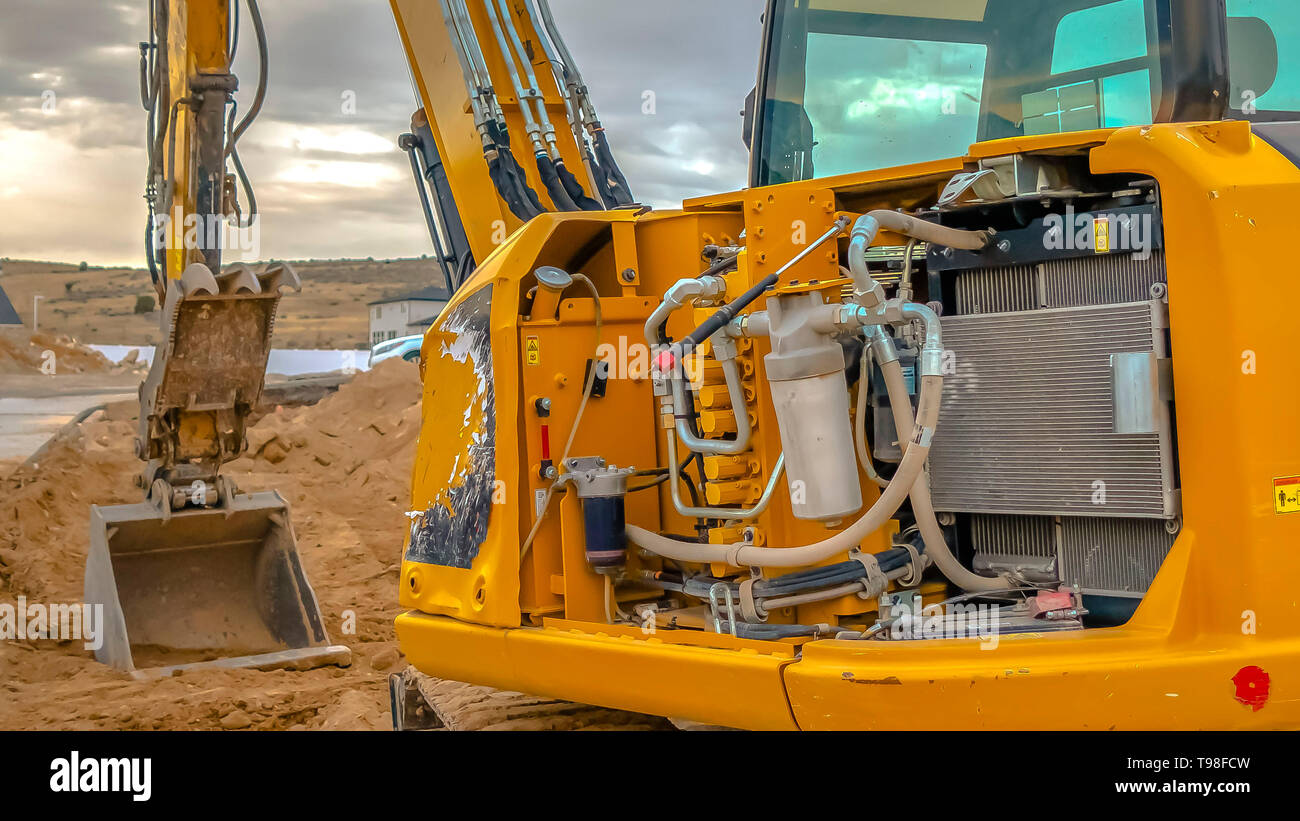 Clear Panorama Construction site with an excavator against a dramatic ...