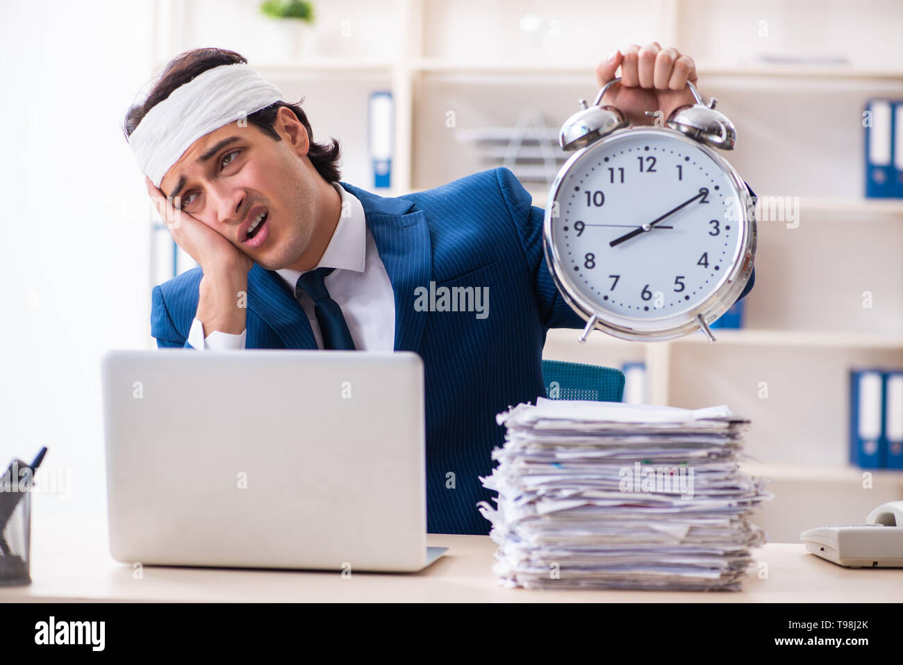 Head injured male employee working in the office Stock Photo - Alamy