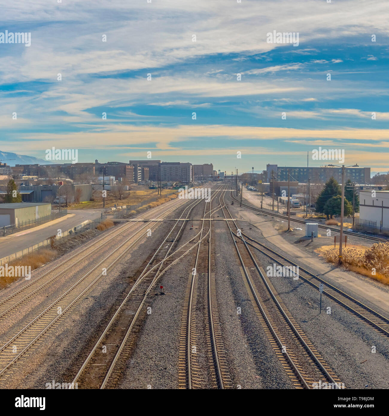 Clear Square Railroad tracks and roads with mountain and vibrant cloudy ...
