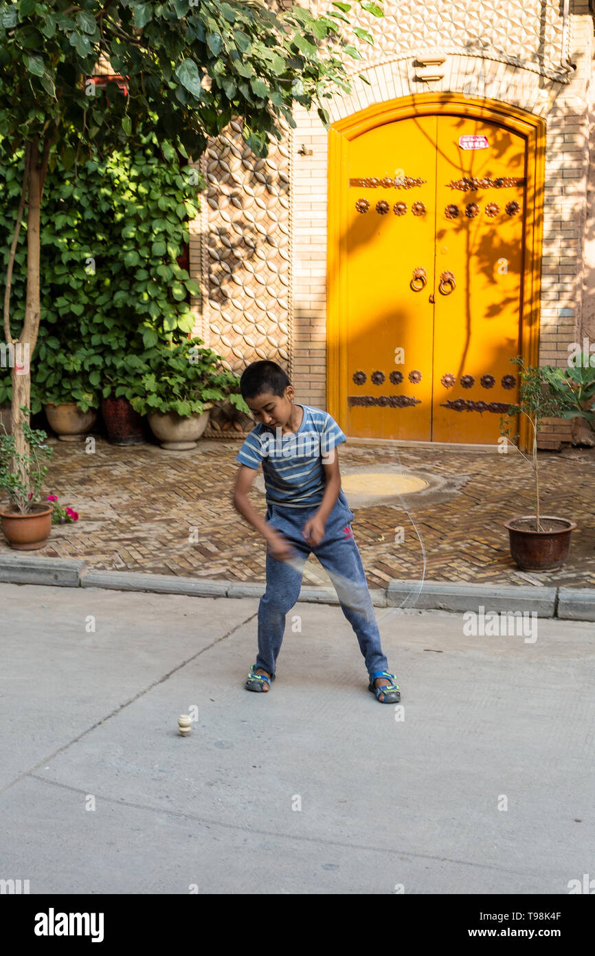 Boy playing spinning top hi-res stock photography and images - Alamy